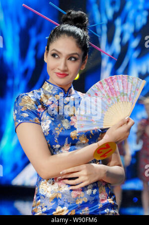 A foreign model displays a creation of cheongsam, also known as qipao ...