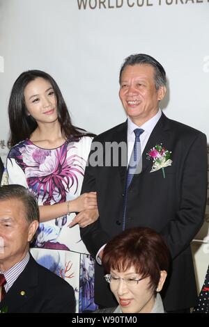 Chinese actress Tang Wei, back left, poses with her father Tang Yuming ...