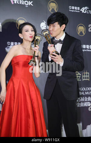 Malaysian singer Penny Tai, left, poses with her Taiwanese husband ...