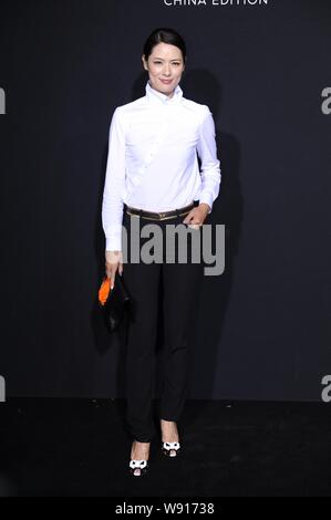 Chinese fashion designer Mary Ma Yanli poses as she arrives for an ...