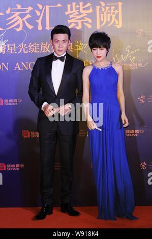 Chinese actor Lu Yi, left, and his actress wife Bao Lei attend the premiere of the micro movie ...