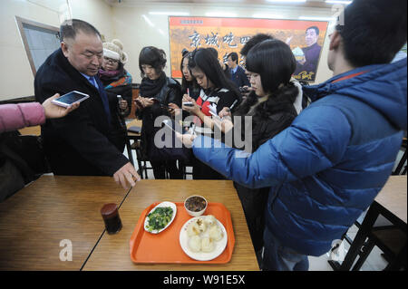 Visitors take photos of the same set of meals ordered by Chinese ...