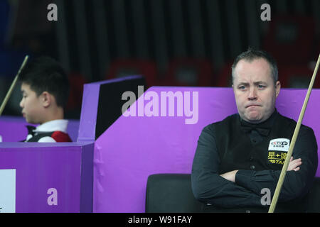 Joe Swail of Northern Ireland watches John Higgins of Scotland playing ...