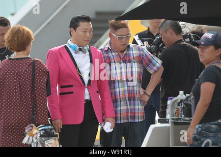 South Korean rapper Psy, left, talks with Hong Kong director Chin Kwok ...