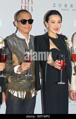 Chinese actor Tony Leung and his wife Carina Lau walk the red carpet ...