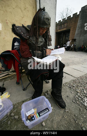 --FILE--Young Chinese man Ding Cong shows his actor permit in a house ...