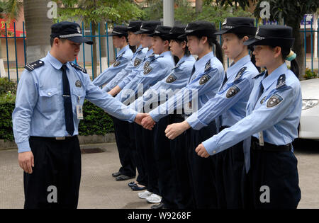 A female Chinese security stands guard at the south entrance of the ...