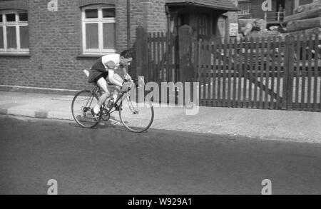 1950s, historical, daytime and an amateur cyclist on a racing bicycle ...