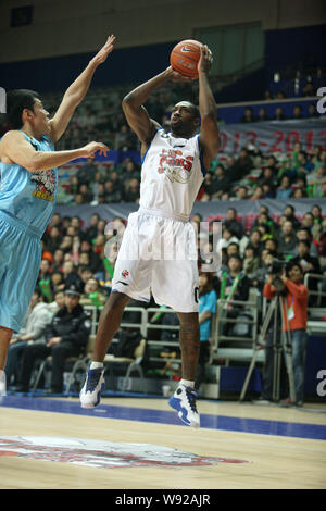 Gilbert Arenas of the Shanghai Sharks, left, challenges a teammate ...