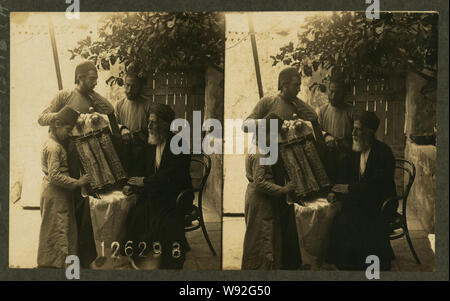 A Samaritan high priest and his sons, with the most ancient copy of the ...