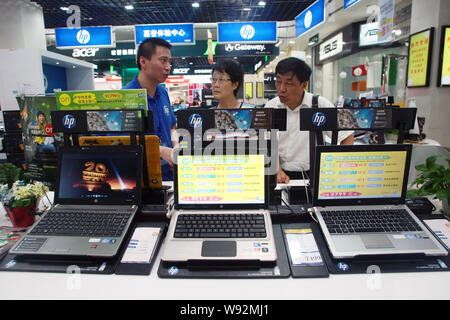 --FILE--Customers shop for laptop computers at a Media Markt store in ...