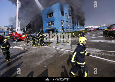 Chinese firemen try to extinguish a fire in an LPG tank storage station ...