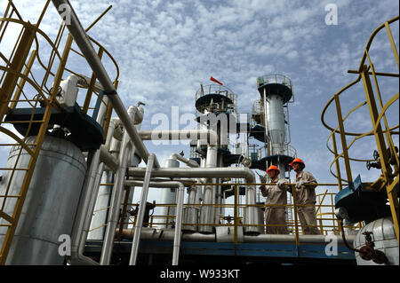 --FILE--Chinese workers examine refining equipment at a refinery of ...