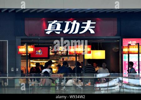 Customers eat at a Kungfu fast-food restaurant in Shanghai, China, 20 ...