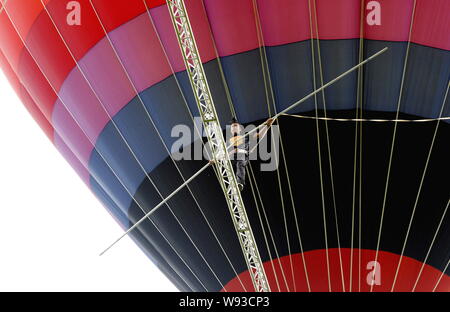 Chinese Uighur tightrope walker Aisikaier Wubulikaisimu holds up his ...