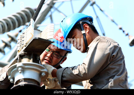 Chinese electricians of the State Grid Corporation of China check and ...