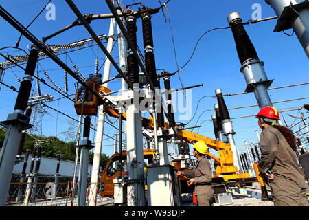 Chinese electricians of the State Grid Corporation of China check and ...
