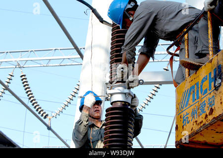 Chinese electricians of the State Grid Corporation of China check and ...