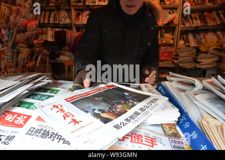 Newspapers of the latest edition of Southern Weekly are for sale at a ...