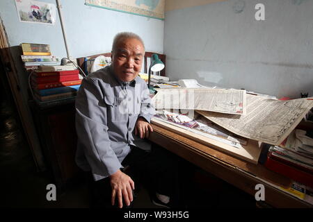 Chinese amateur cartographer Yu Nianchun poses next to his reference ...