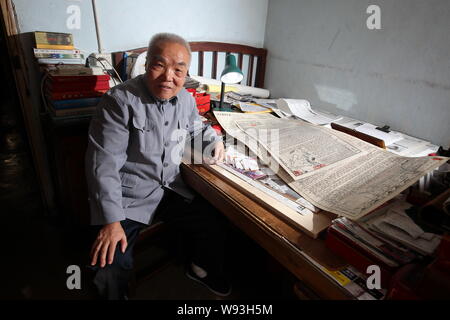 Chinese amateur cartographer Yu Nianchun poses next to his reference ...
