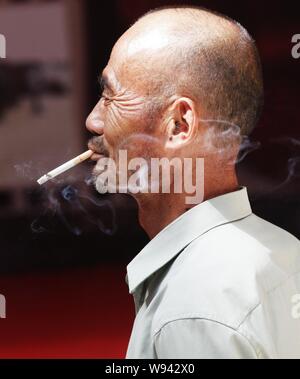Chinese smoker / man smoking / smokes a cigarette in Sichuan Stock ...