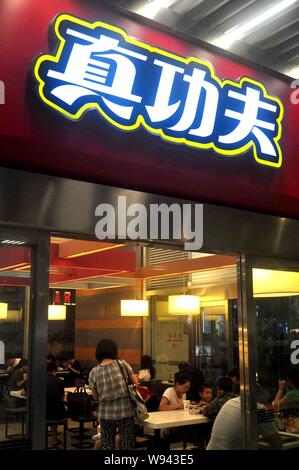 Customers eat at a Kungfu fast-food restaurant in Shanghai, China, 20 ...