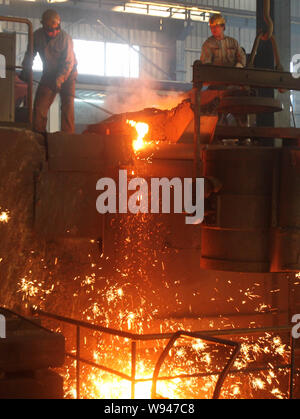 --FILE--Chinese workers produce steel at a steel plant in Taiyuan city ...