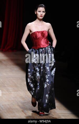 Chinese model Mo Wandan displays a new creation by Hong Kong designer ...