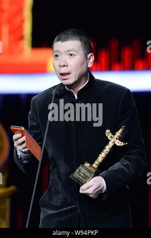 Chinese director Feng Xiaogang holds his award for Best Director at the ...