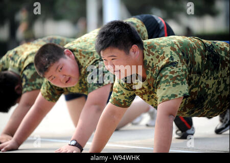 Obese Chinese children perform push-ups at an exercise during a ...