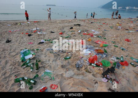 Garbage on a beach left by tourists, environmental pollution concept ...