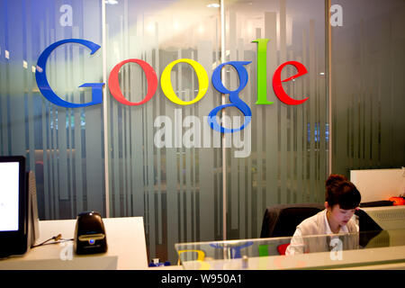 A receptionist works at the reception desk of Google at the ...