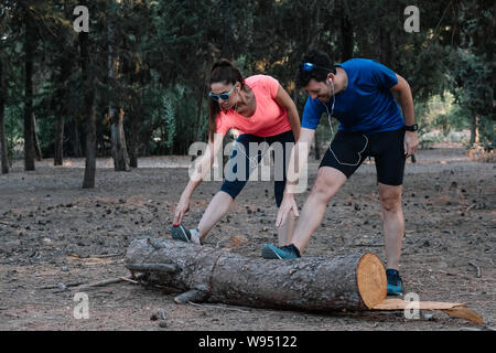 Man and woman doing outdoor fitness training together at a park ...
