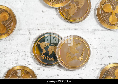Top down view - XRP ripple cryptocurrency golden coins on white stone ...