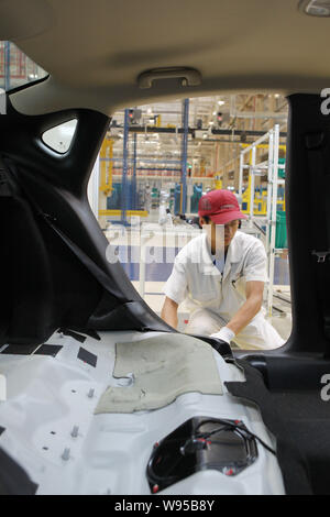 A Chinese worker assembles a Fiat Viaggio car on the assembly line at ...
