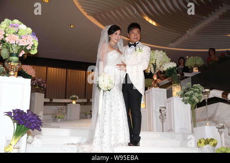 Hong Kong actor Chin Ka Lok, right, strokes the belly of his pregnant ...