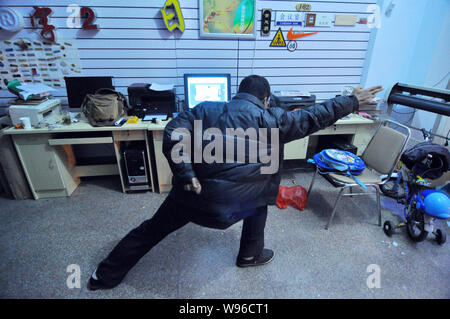 A Chinese man mimics the hand signals of flight deck crew directing J ...