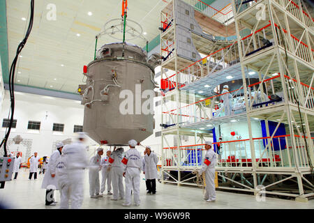 Chinese aerospace engineers check the orbital and re-entry modules of ...