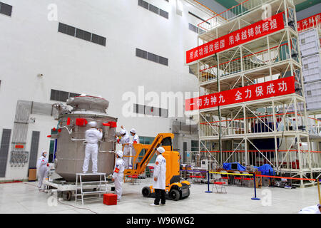 Chinese aerospace engineers check the orbital and re-entry modules of ...