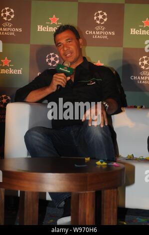 Former Dutch soccer star Ruud Gullit poses with a fan during a ...