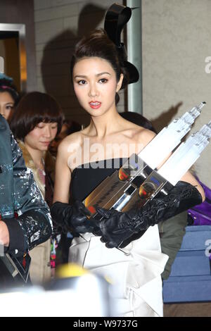 Hong Kong singer and actress Fiona Sit poses with her trophies after ...