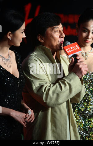 Famous action star Jackie Chan (M) poses with cast member of his new ...