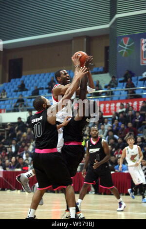 Tracy McGrady of the Qingdao Eagles, top, prepares to shoot against the ...