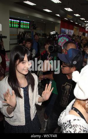Members of Japanese pop idol girl group Morning Musume wave at a ...