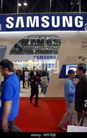 --File--Visitors are seen at the stand of Samsung during a fair in ...