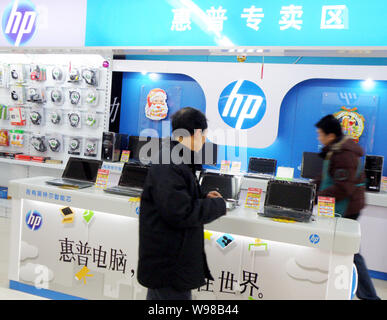 Chinese customers shop for HP (Hewlett-Packard) laptop computers at a ...