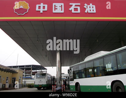 --FILE--Buses are being refueled at a gas station of Sinopec and Shell ...