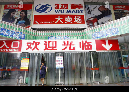 A Chinese shopper walks out from a Huawei store in Hangzhou City, east ...