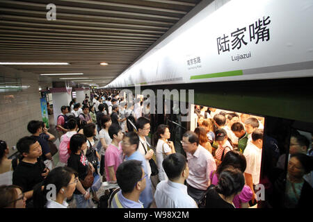 --FILE--Crowds of passengers walk in and out of a train of the ...